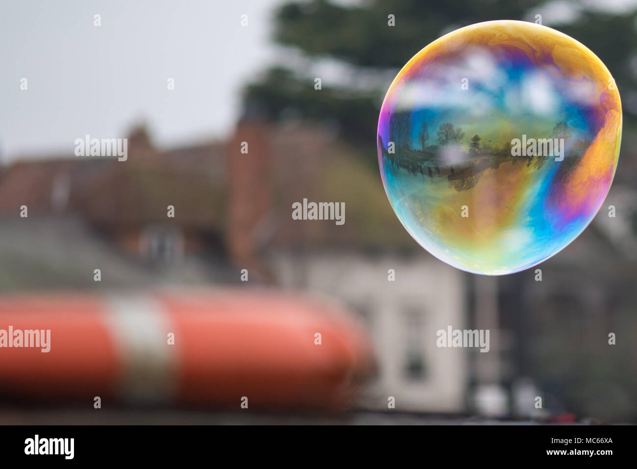 bubble reflecting seaside scene with boat in the foreground and space ...
