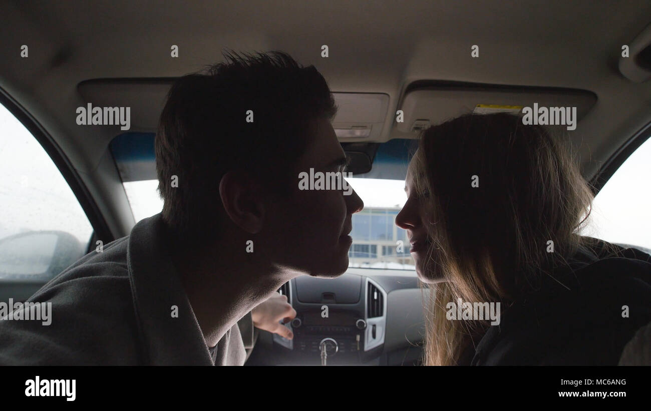 Young cute couple hugging and kissing in a car Stock Photo - Alamy