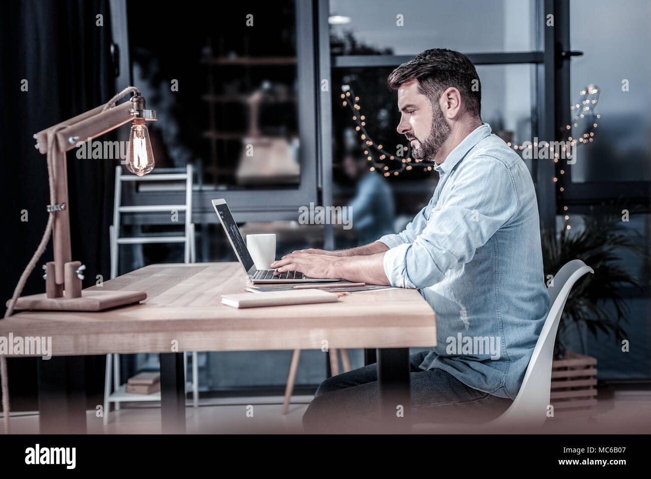 Busy smart employee sitting and using the laptop Stock Photo - Alamy