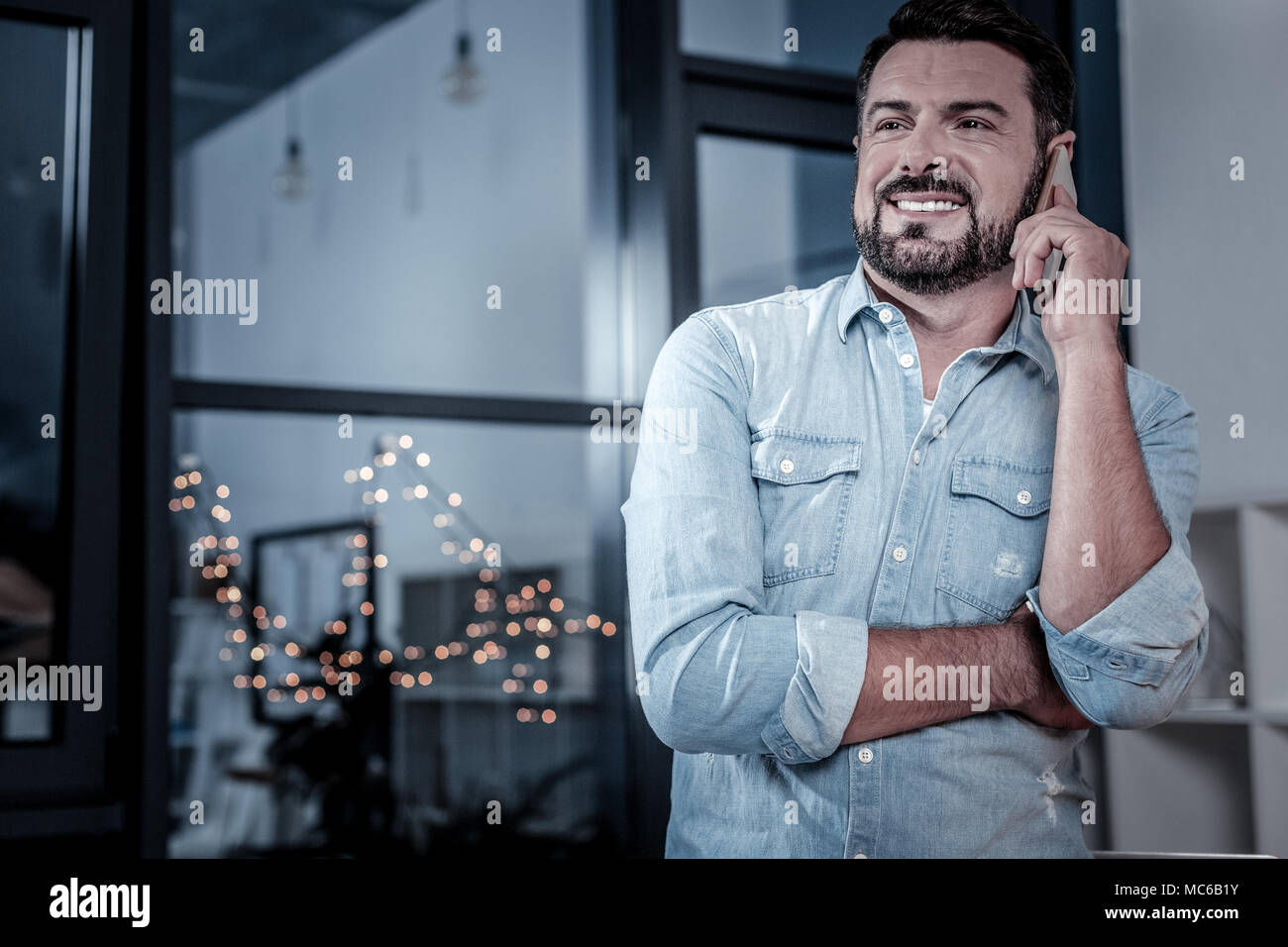 Pleasant joyful man smiling and communicating Stock Photo - Alamy