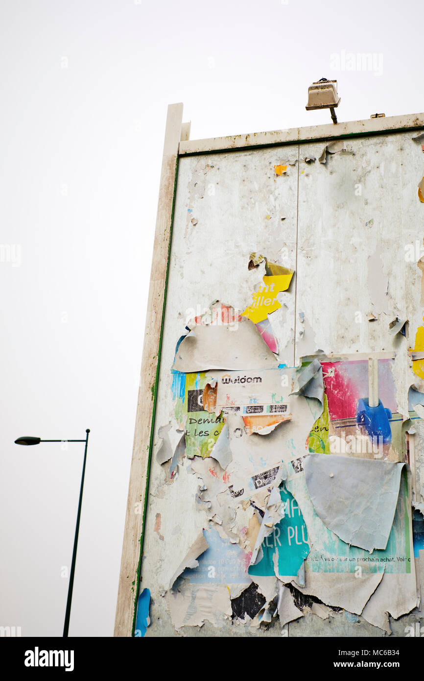 An old torn and weathered paper poster billboard Stock Photo - Alamy