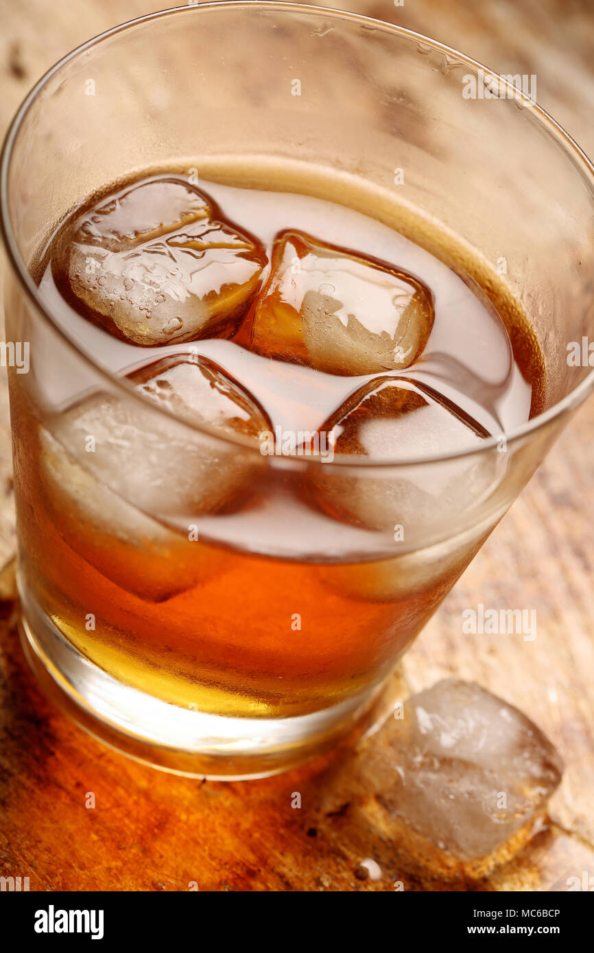 Cold drink with ice on vintage background Stock Photo - Alamy