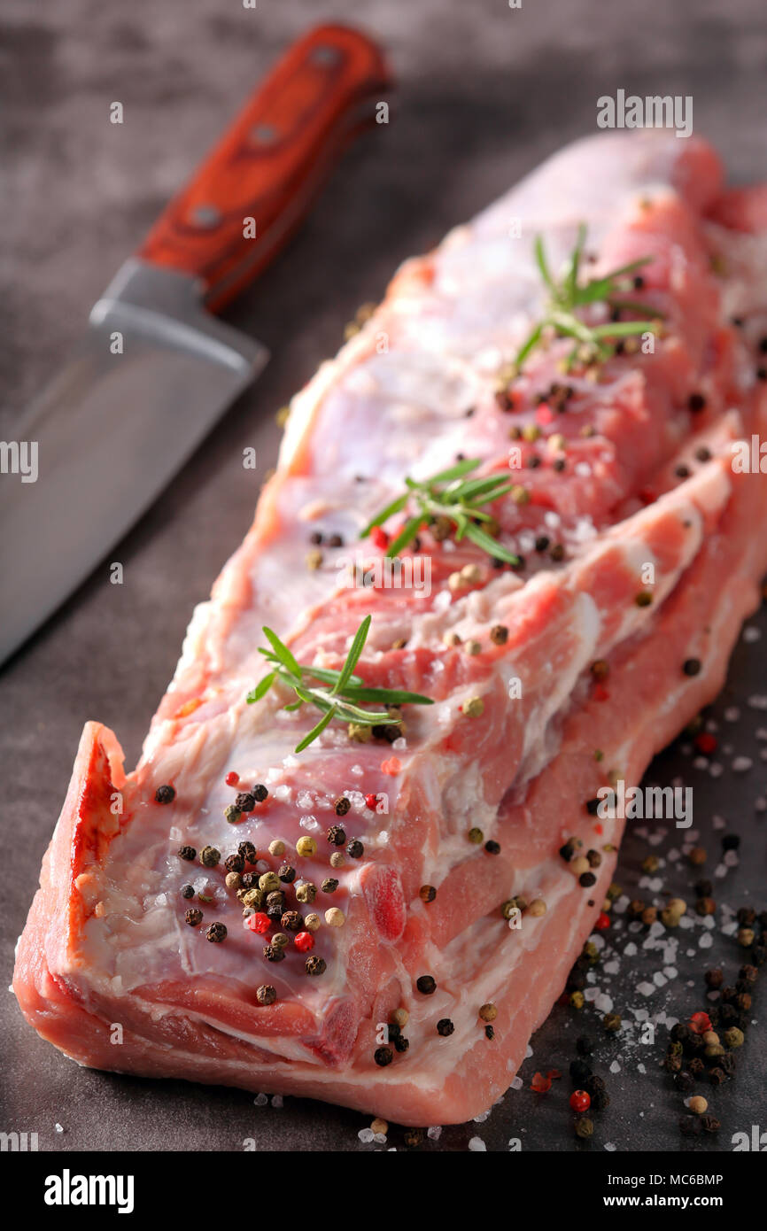 Raw ribs with spices on stone background Stock Photo - Alamy