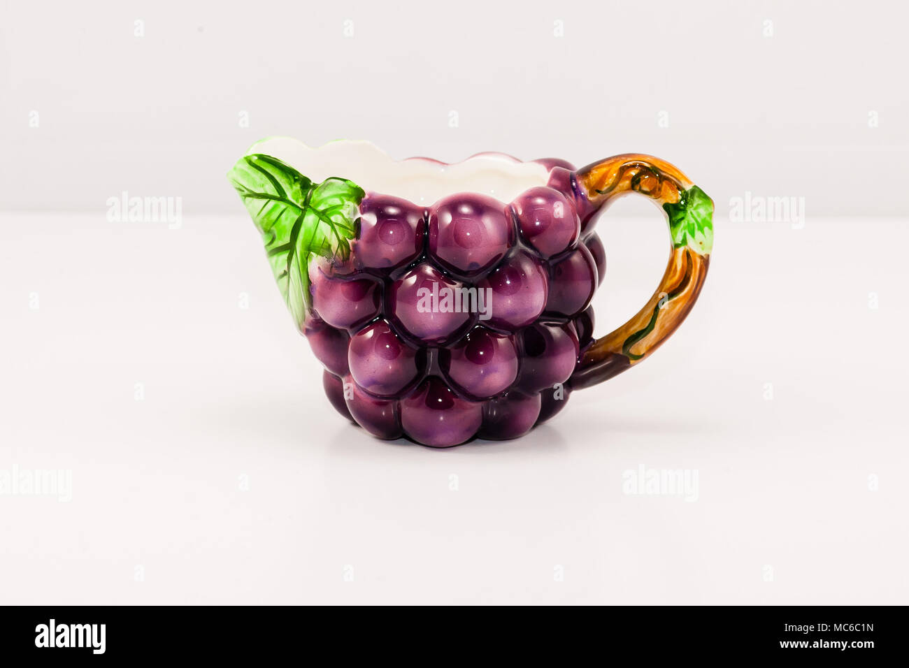 ceramic creamer from a grape design set Stock Photo - Alamy