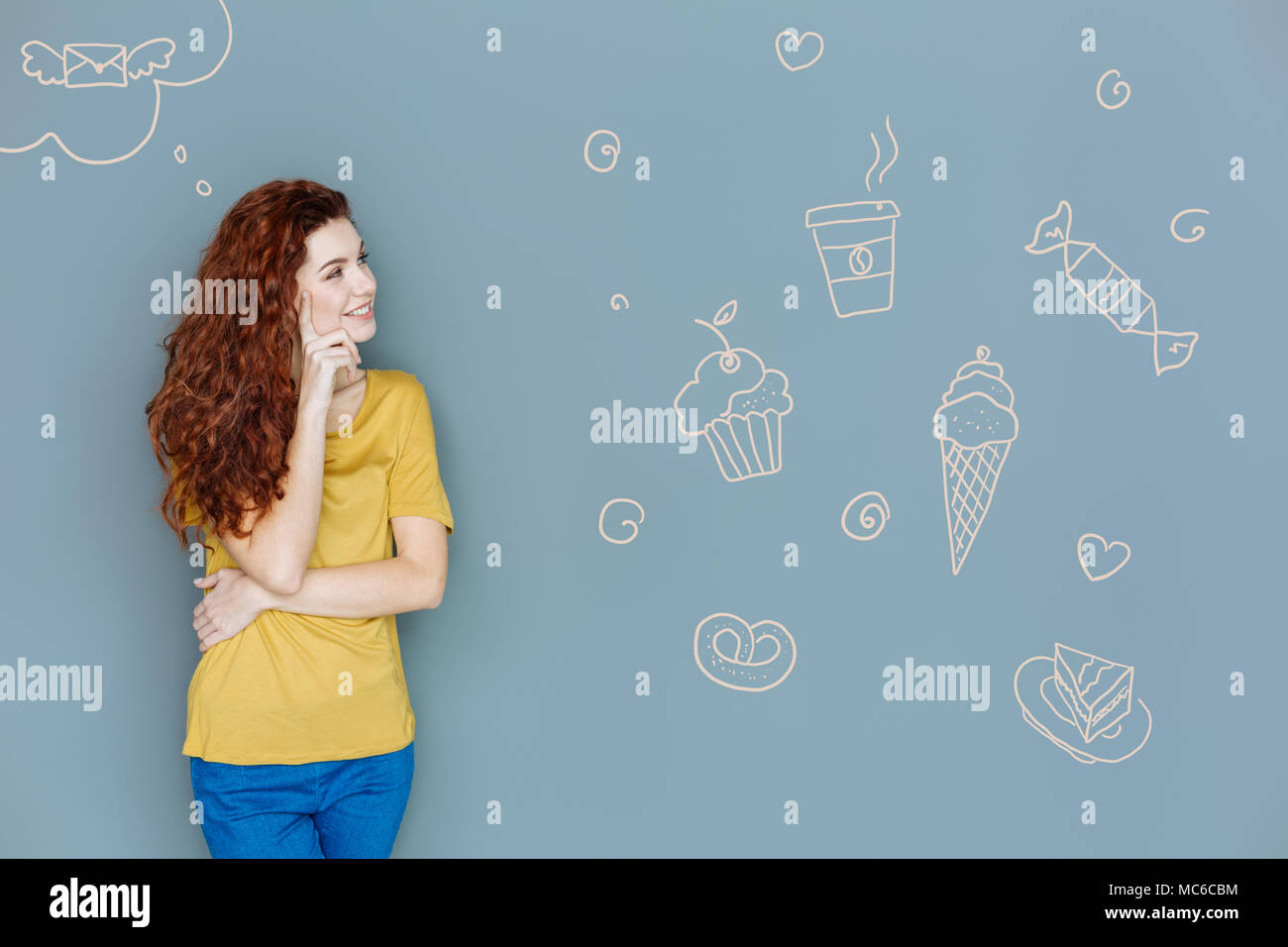 Hungry student smiling while thinking about tasty sweets Stock Photo ...