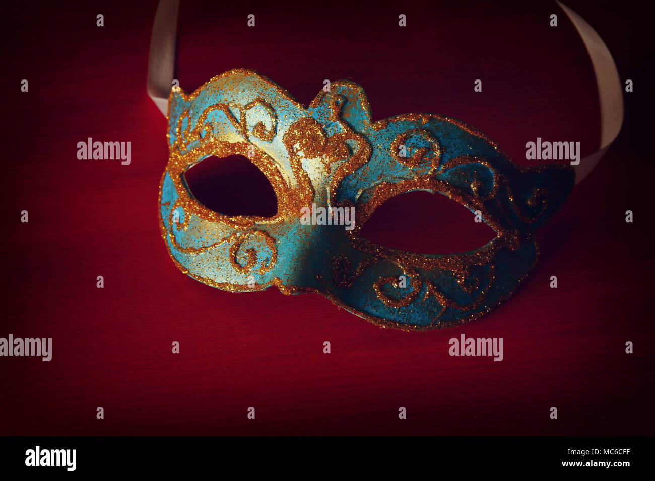 Image of elegant blue and gold venetian mask over red background Stock ...