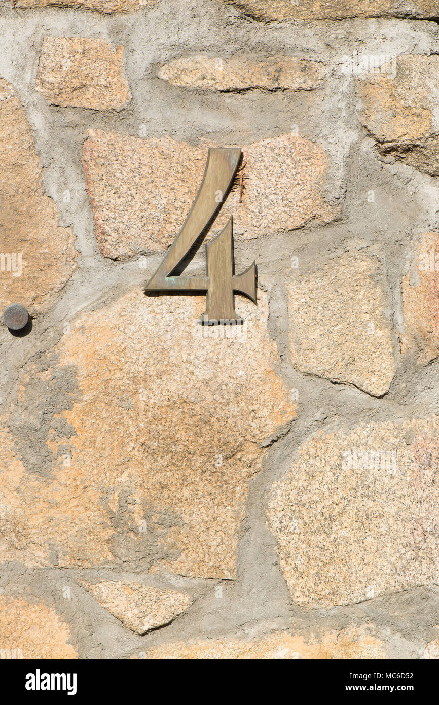 Number four made of metal on a stone wall. Street number Stock Photo ...