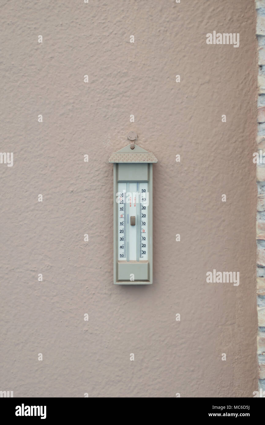 Vintage analog thermometer hanging on a wall Stock Photo - Alamy