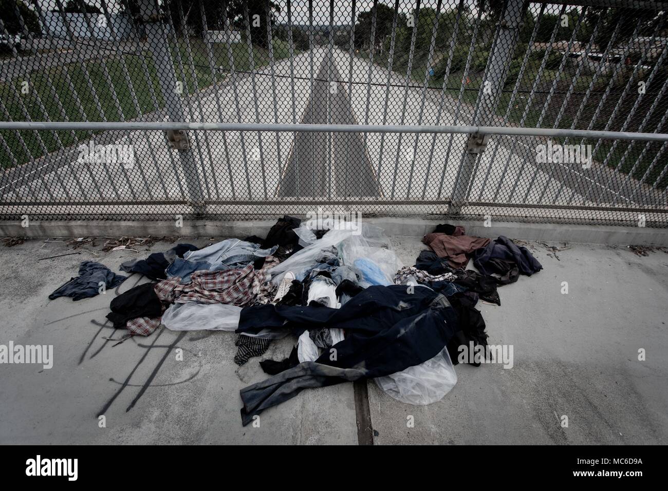 Homeless camp on a pedestrian overpass and an empty highway give the ...