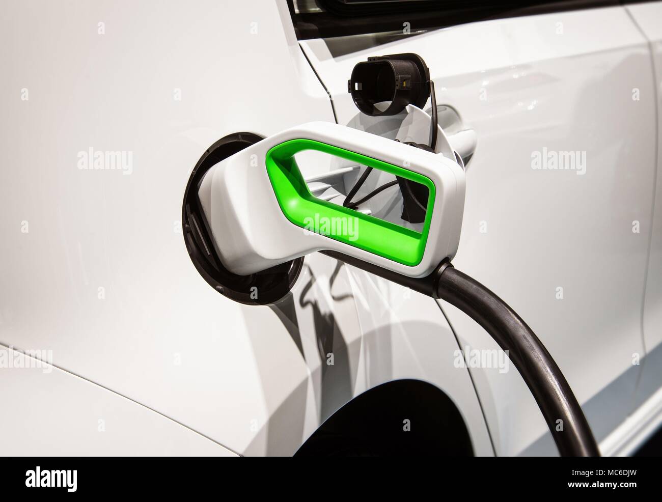 Detail of an electric car with green plug | usage worldwide Stock Photo ...