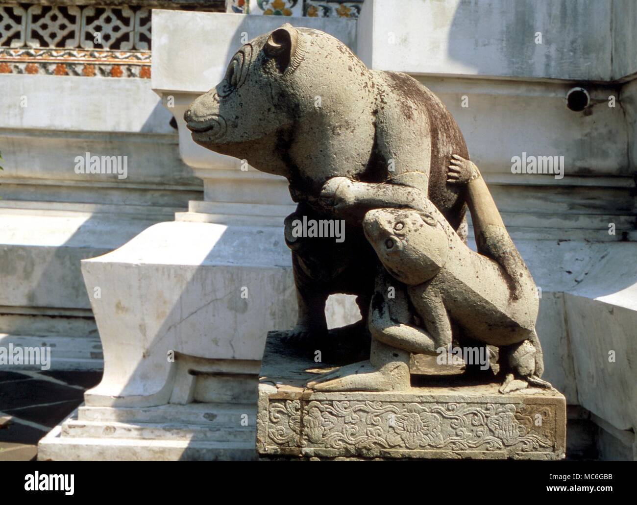 ANIMALS Monkey with young. Stone statue in the gardens of the temple of ...