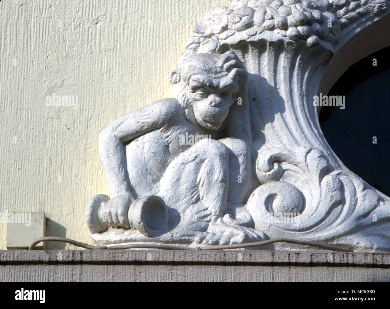 ANIMALS Monkey, presumably preparing food. Relief carving above the ...