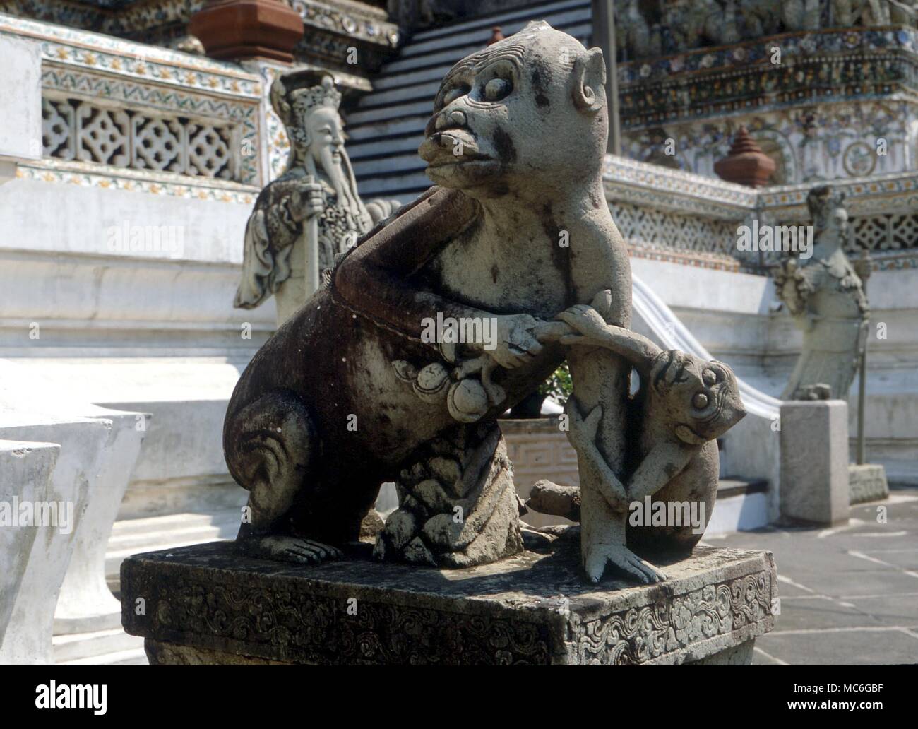 ANIMALS Monkey with young. Stone statue in the gardens of the temple of ...
