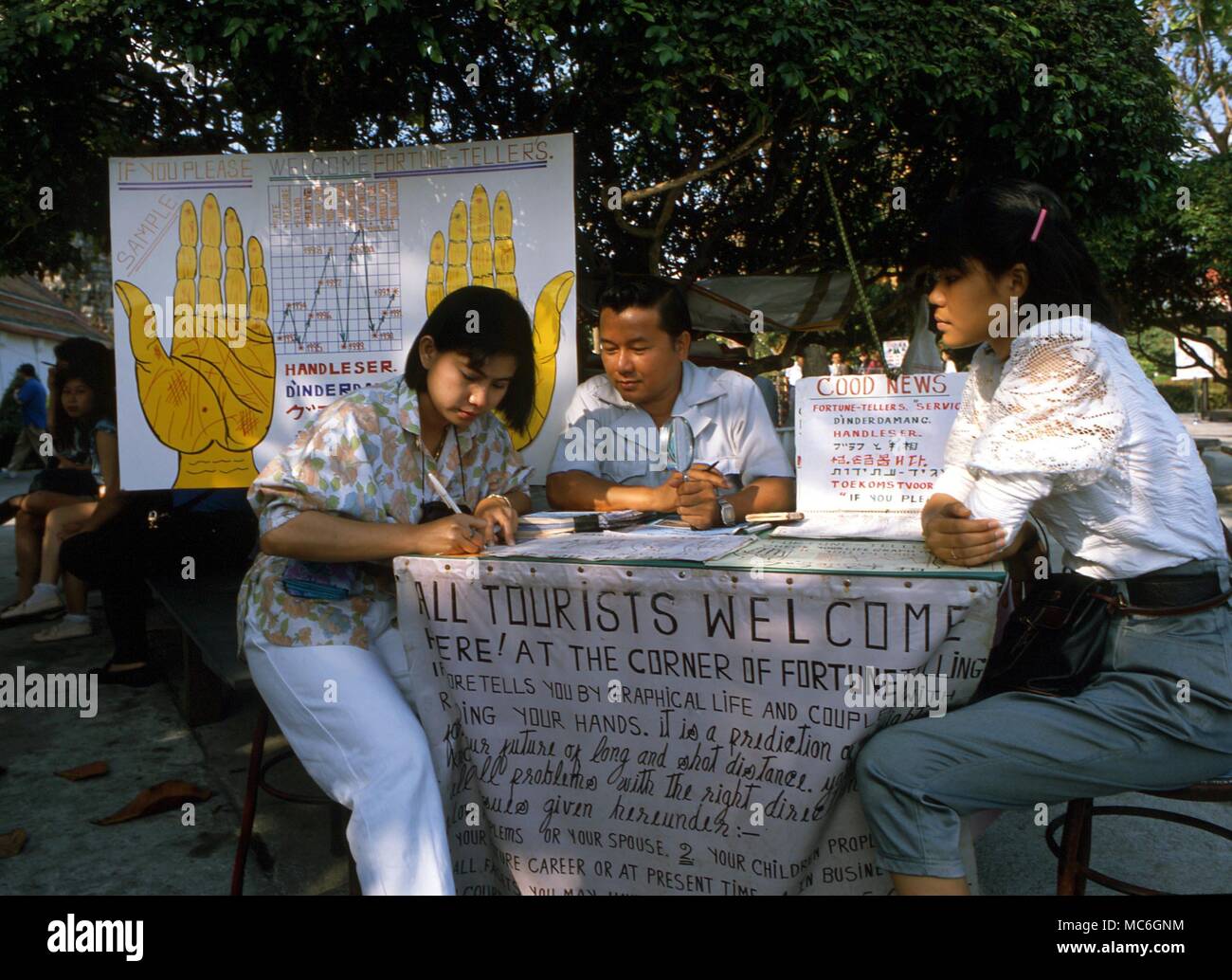PALMISTRY - Street palmist outside a Temple in Bangkok, Thailand Stock ...