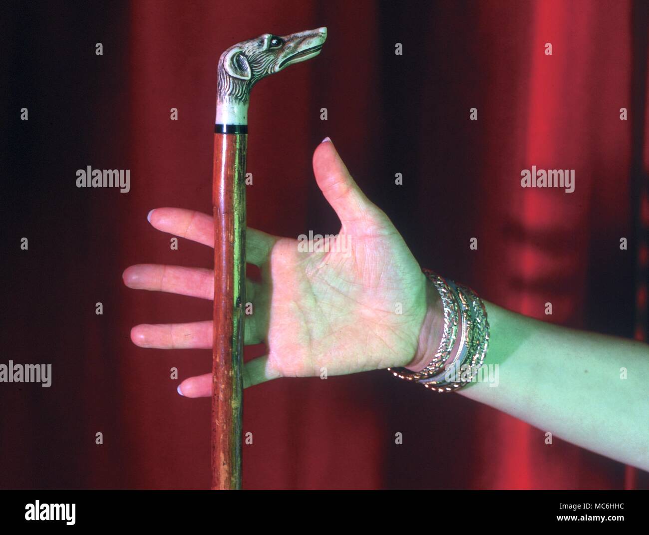 Magicians Hands mesmerizing a magical stick Stock Photo - Alamy