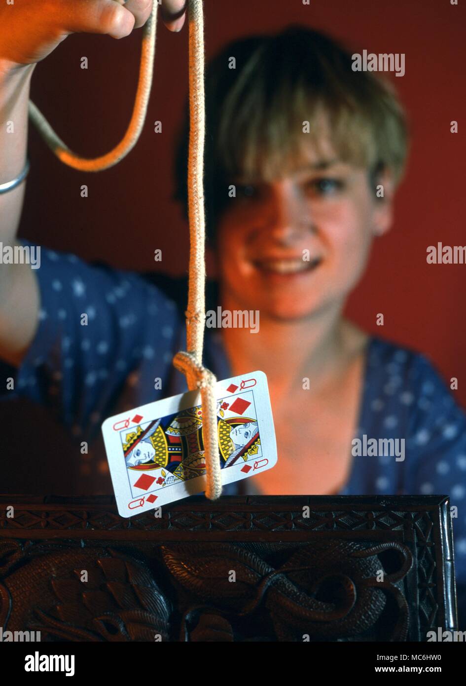 Stage Magic - Magic rope. The magician's assistant dangles a rope end ...