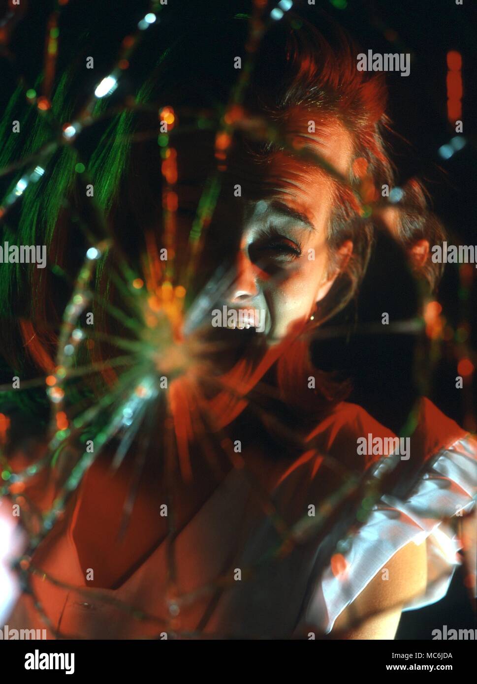 FANTASY - FEAR. A girl screaming into a broken mirror Stock Photo - Alamy
