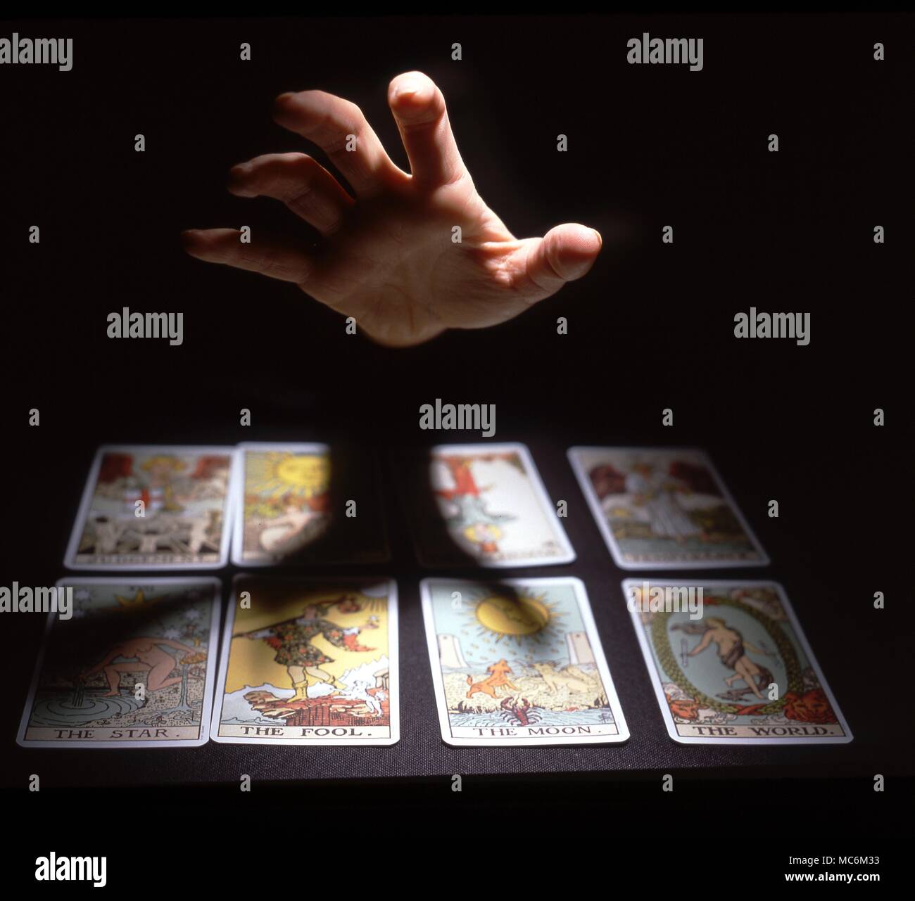 Hand hovering over Tarot Cards Stock Photo - Alamy