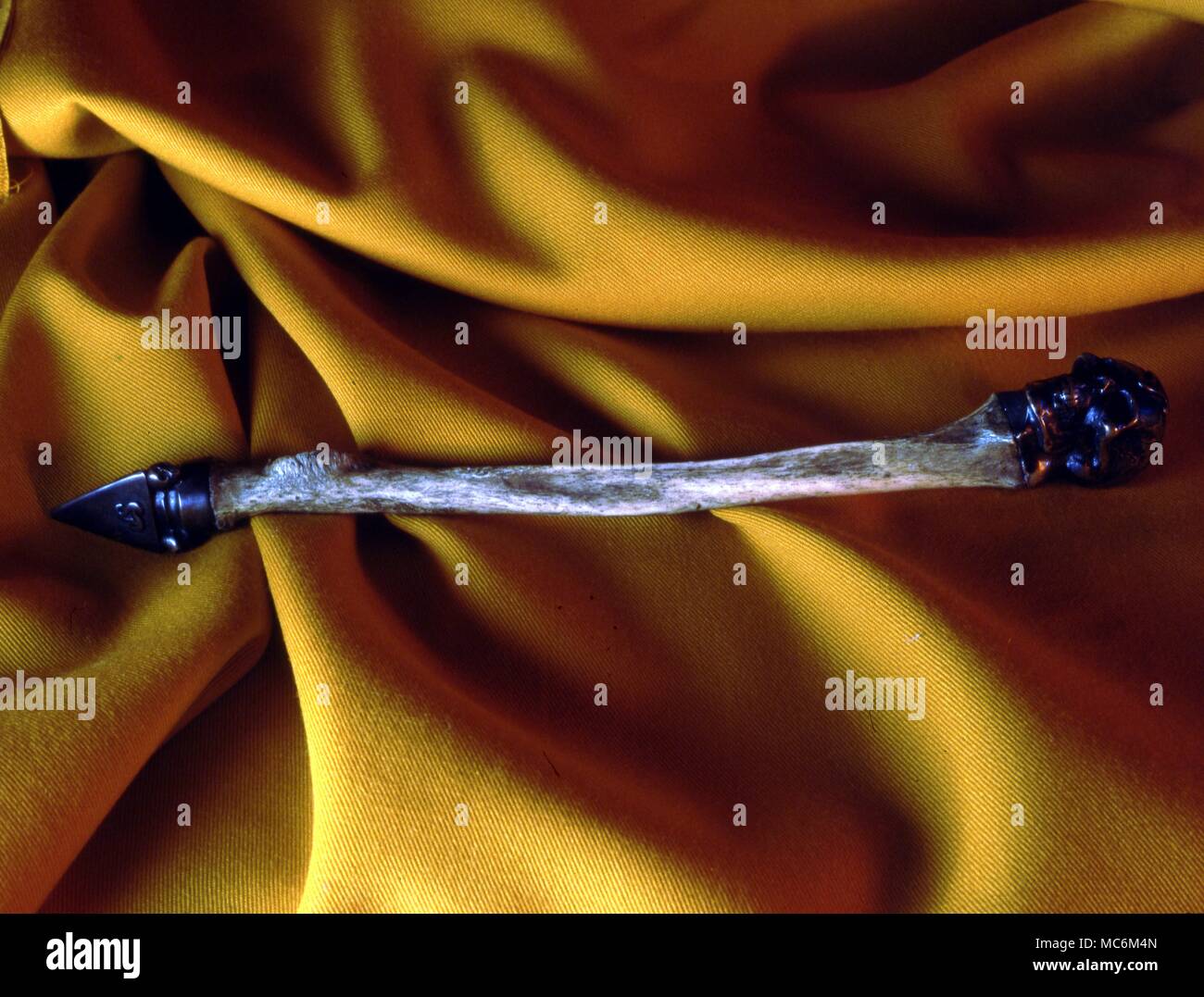 Ritual rod made from a human bone with skull and triquets symbol, used ...
