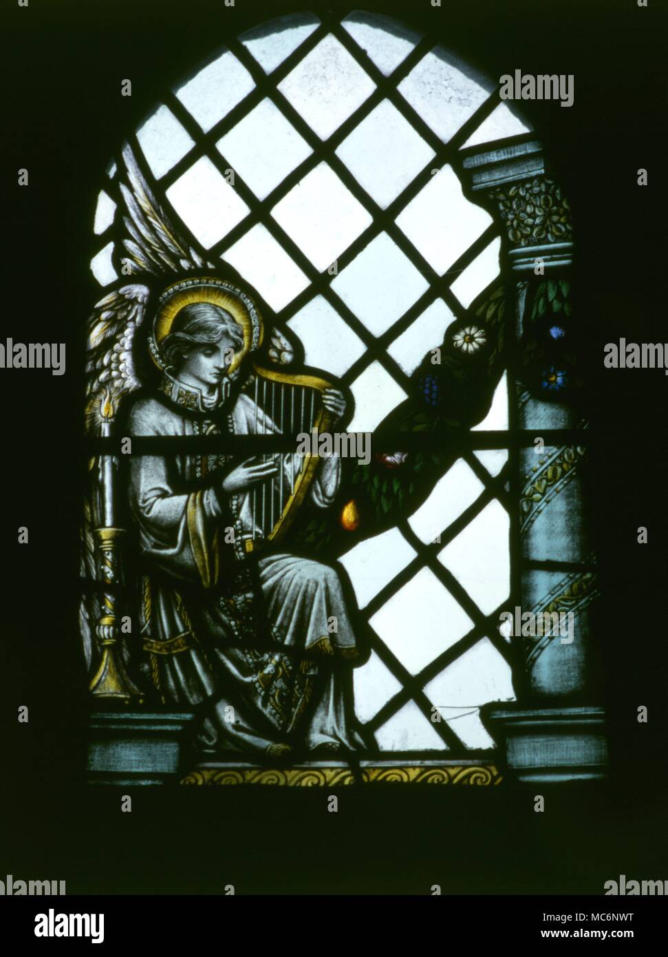 Winged angel playing a harp. Stained glass detail from the cloister ...