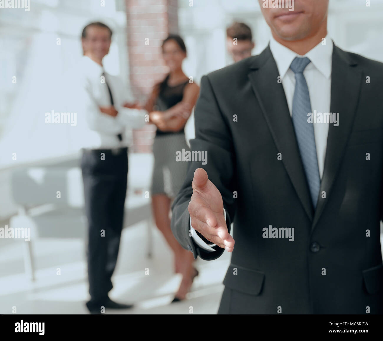 successful businessman giving a hand Stock Photo - Alamy