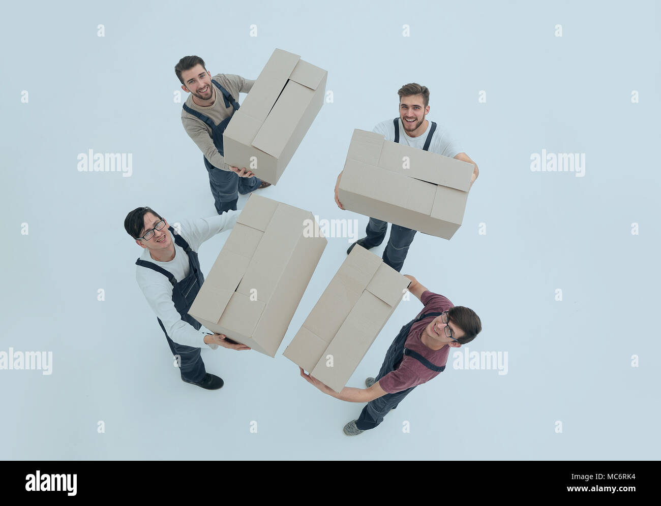 Movers lifting stack of cardboard moving boxes isolated on white Stock ...