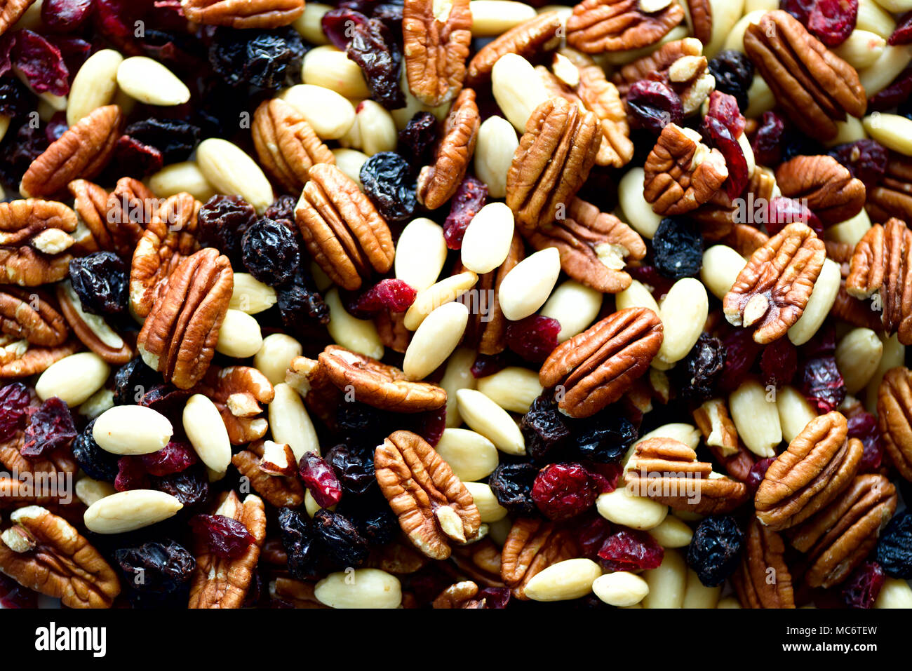 Mixed nuts and raisins in wooden bowl. Healthy food and snack. Walnut ...