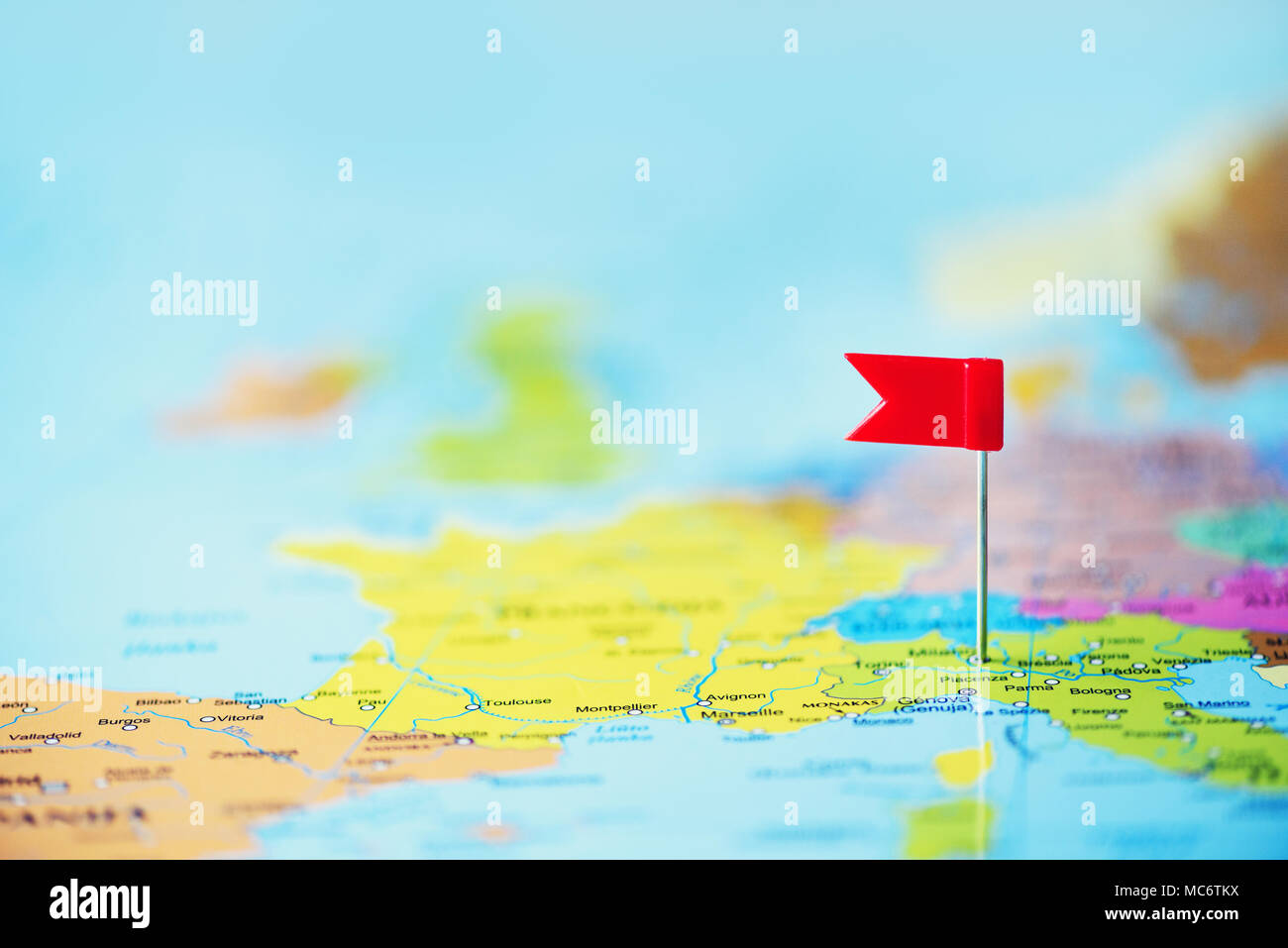 Red flag, pushpin, thumbtack pinned on map of europe. Copy space ...