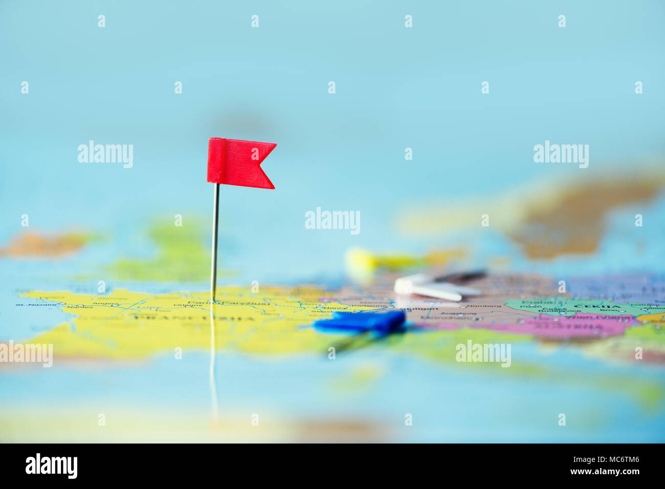 Red flag, pushpin, thumbtack pinned on map of europe. Copy space ...