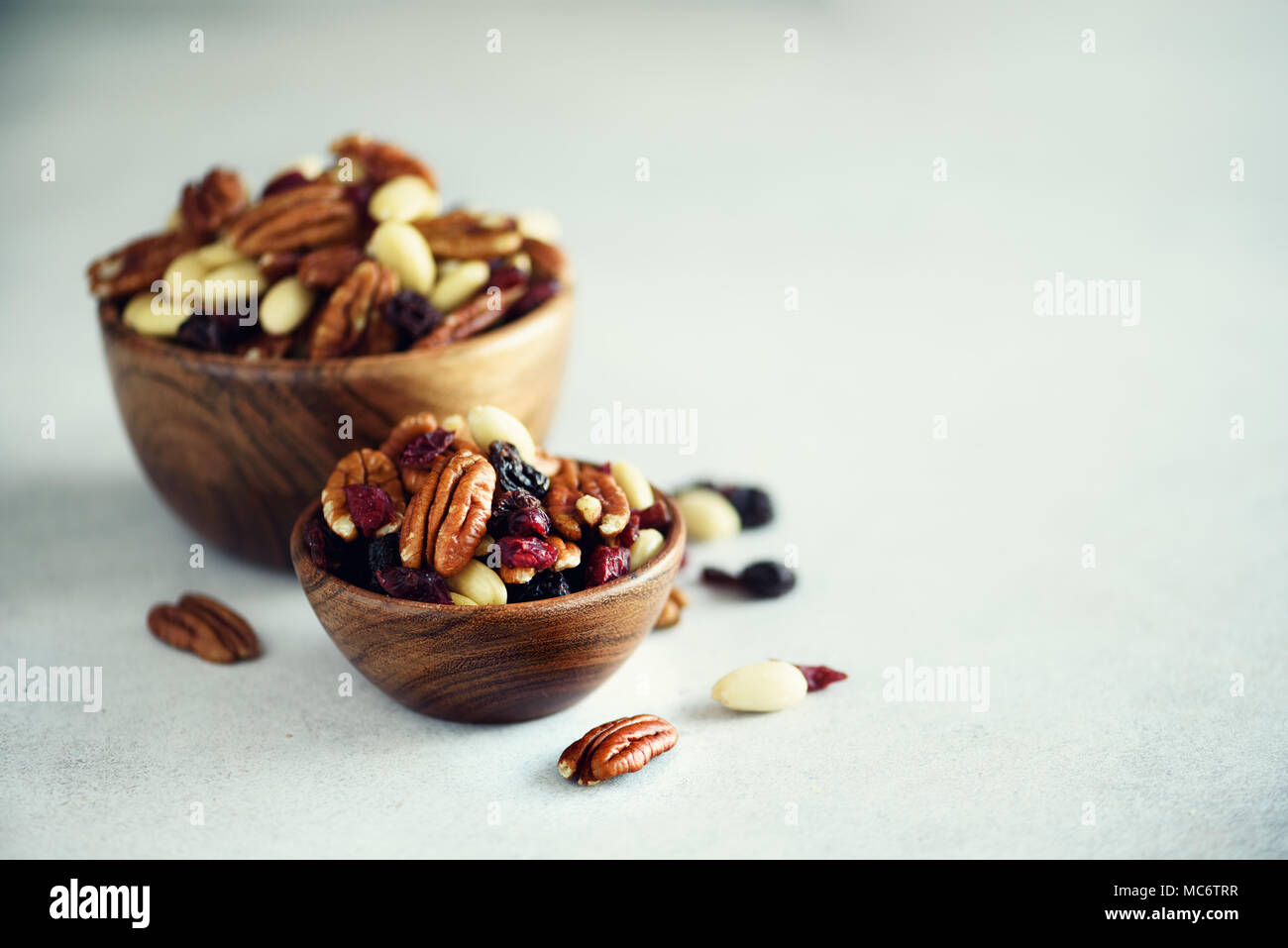 Mixed nuts and raisins in wooden bowl. Healthy food and snack. Walnut ...