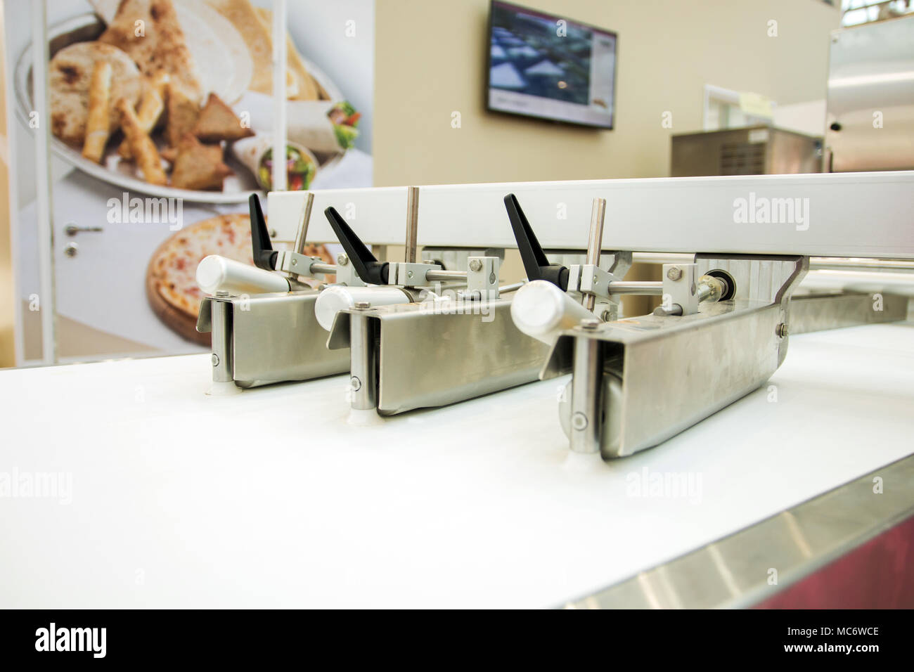 modern and high technology machine with rollers for dough filling ...