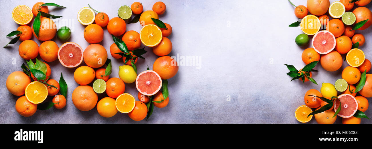 Citrus fruits background. Assorted fresh citrus fruits with leaves ...