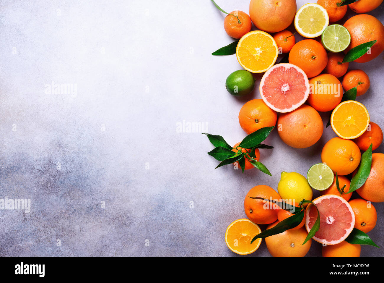 Citrus fruits background. Assorted fresh citrus fruits with leaves ...
