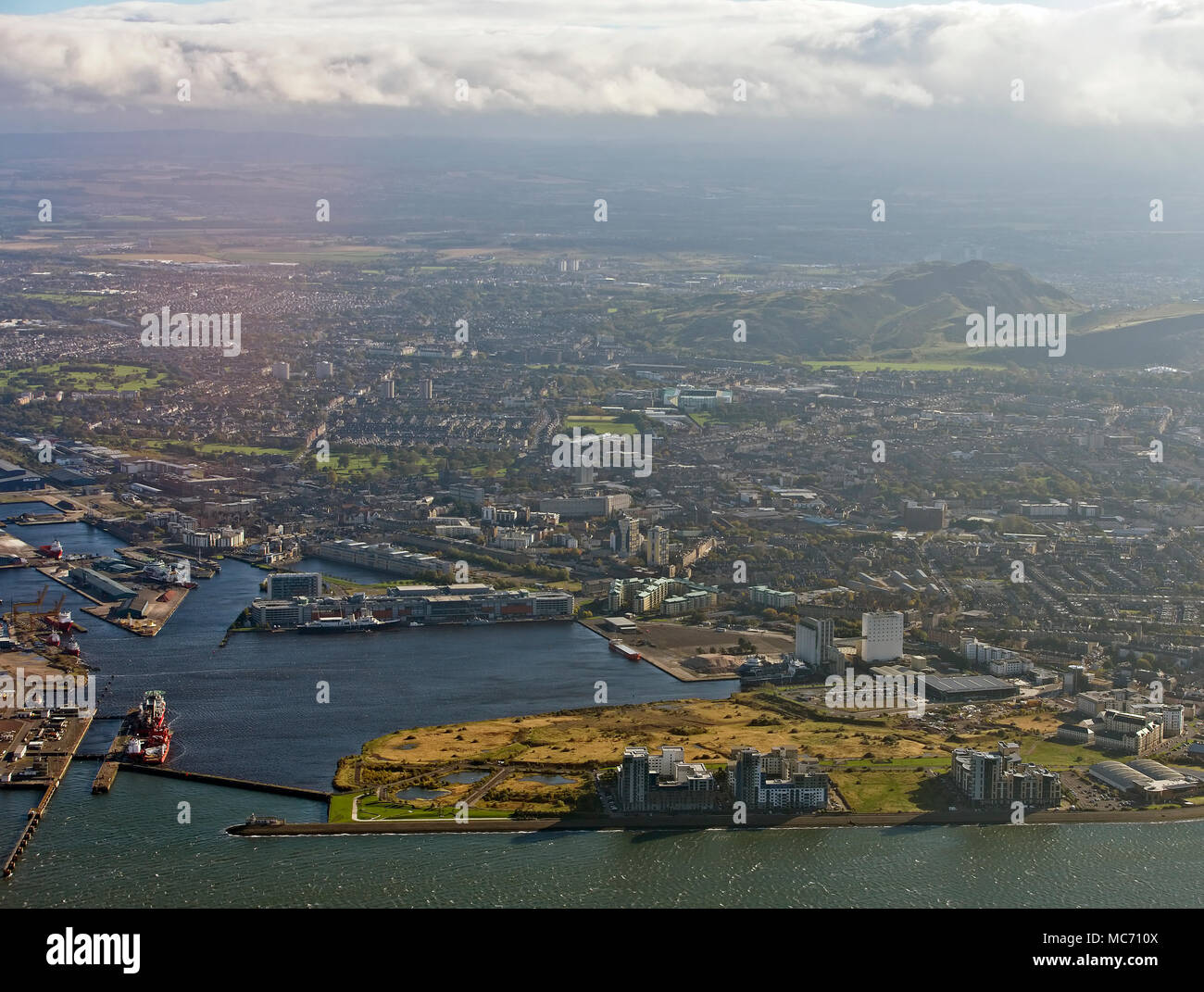 Flying over Edinburgh, the harbour and Arthur's Seat, Scotland, UK ...