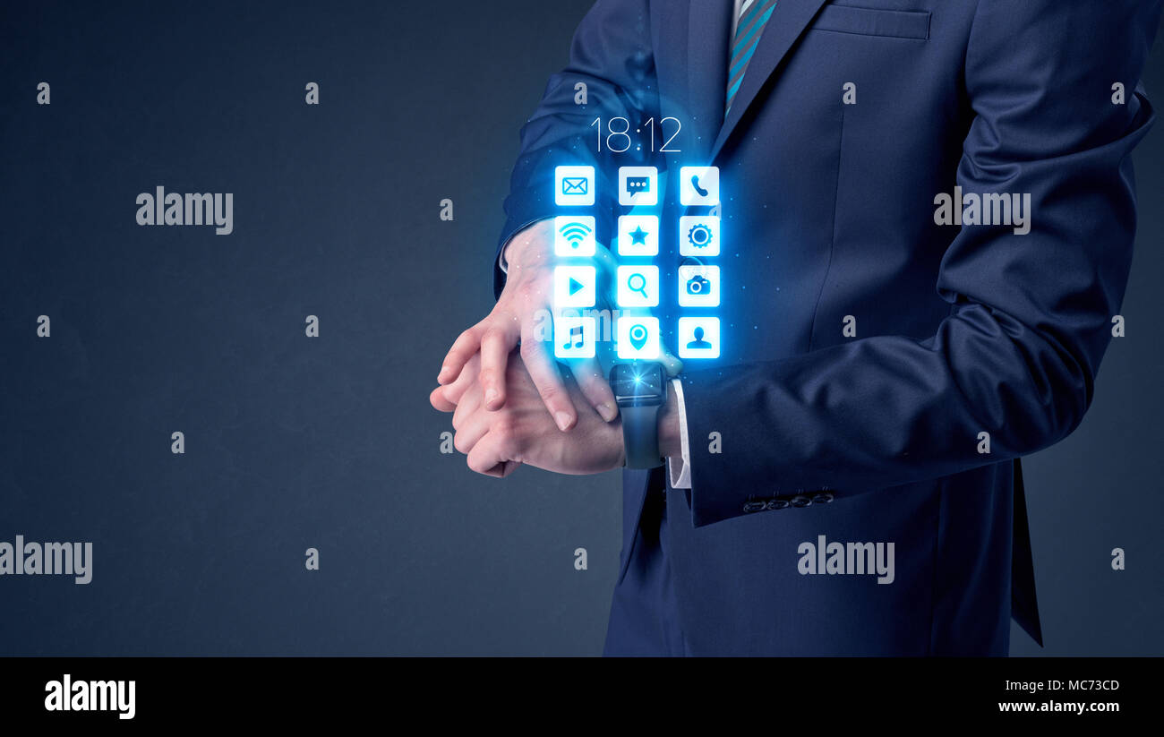 Businessman wearing smartwatch with application icons Stock Photo - Alamy