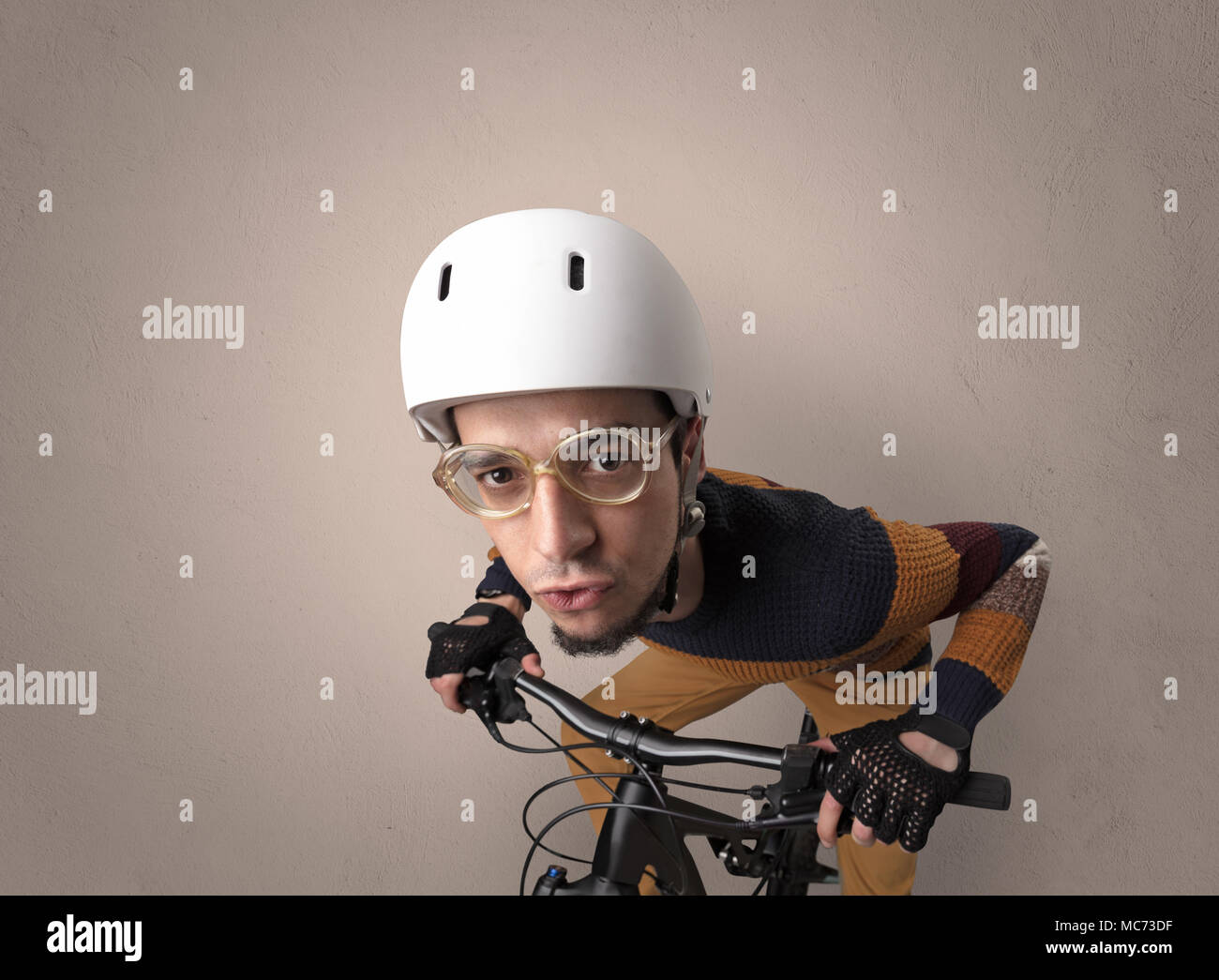 Nerd young foolish biker on a bike with oldschool outfit Stock Photo ...