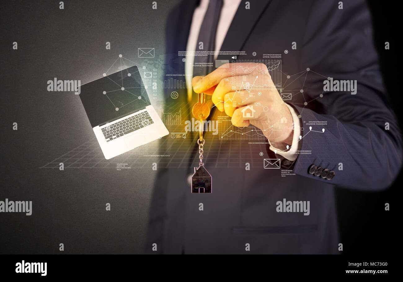 Businessman in suit holding keys with statistics, graphs and icons ...