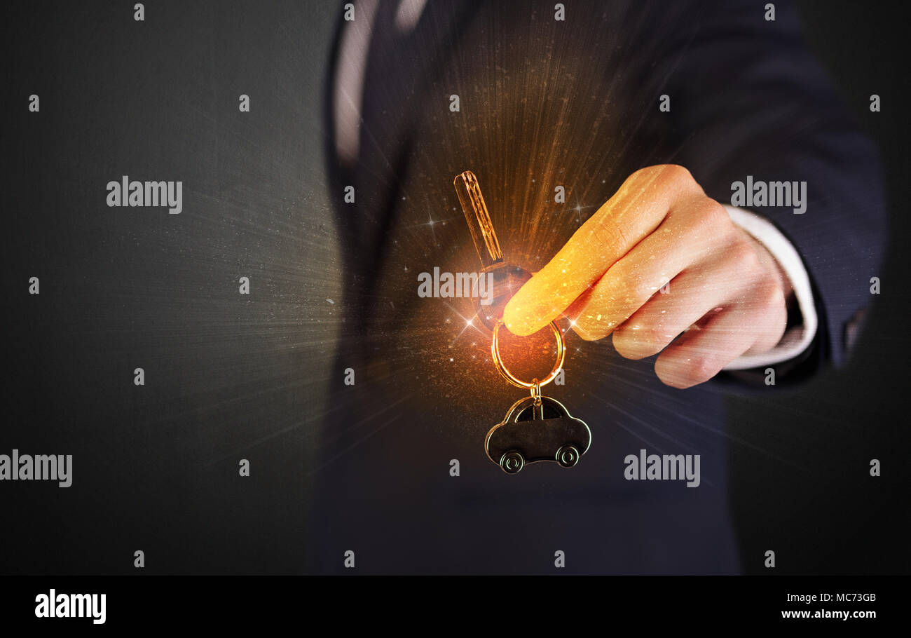 Formal man hand over shiny keys with dark background Stock Photo - Alamy