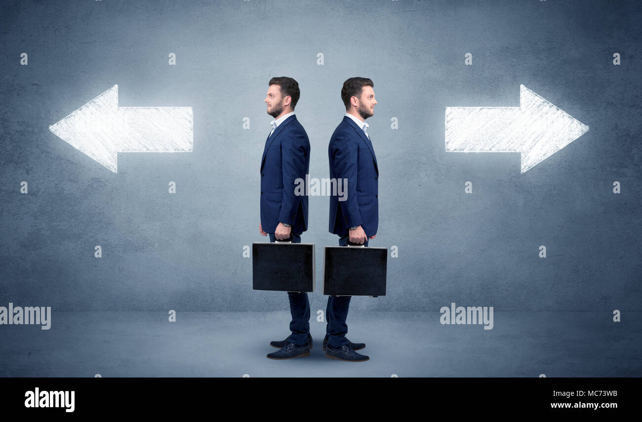 Young conflicted businessman choosing between two directions Stock ...
