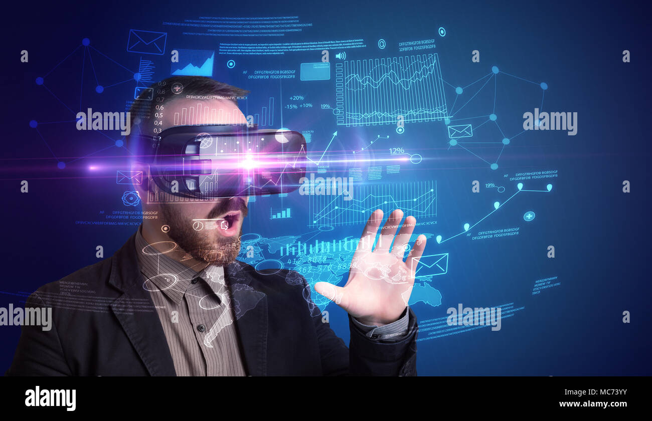 Amazed businessman with virtual reality business plan in front of him ...