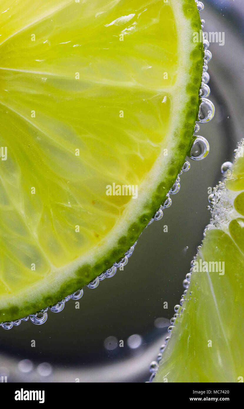Macro Lime Slices in Sparkling water with bubbles Stock Photo - Alamy