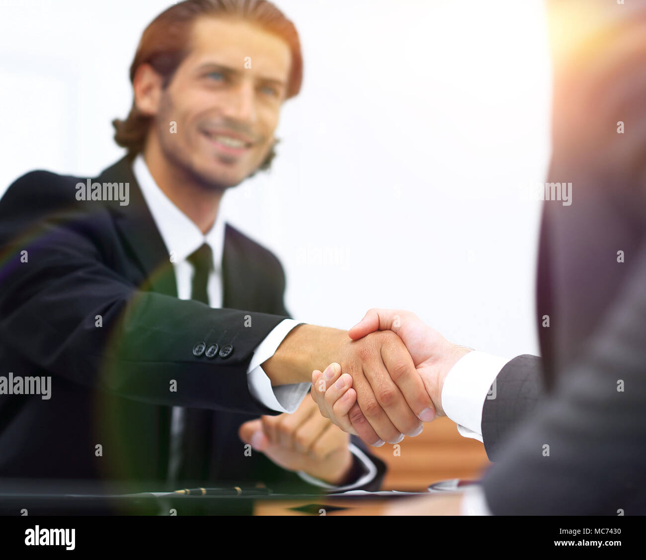 handshake Manager and the client sitting in the office.the concept of ...