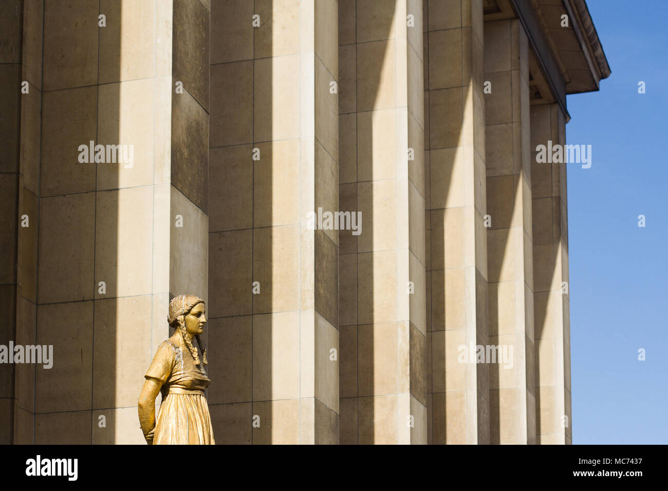 horizontal side view of classical woman statue with tall white marble ...
