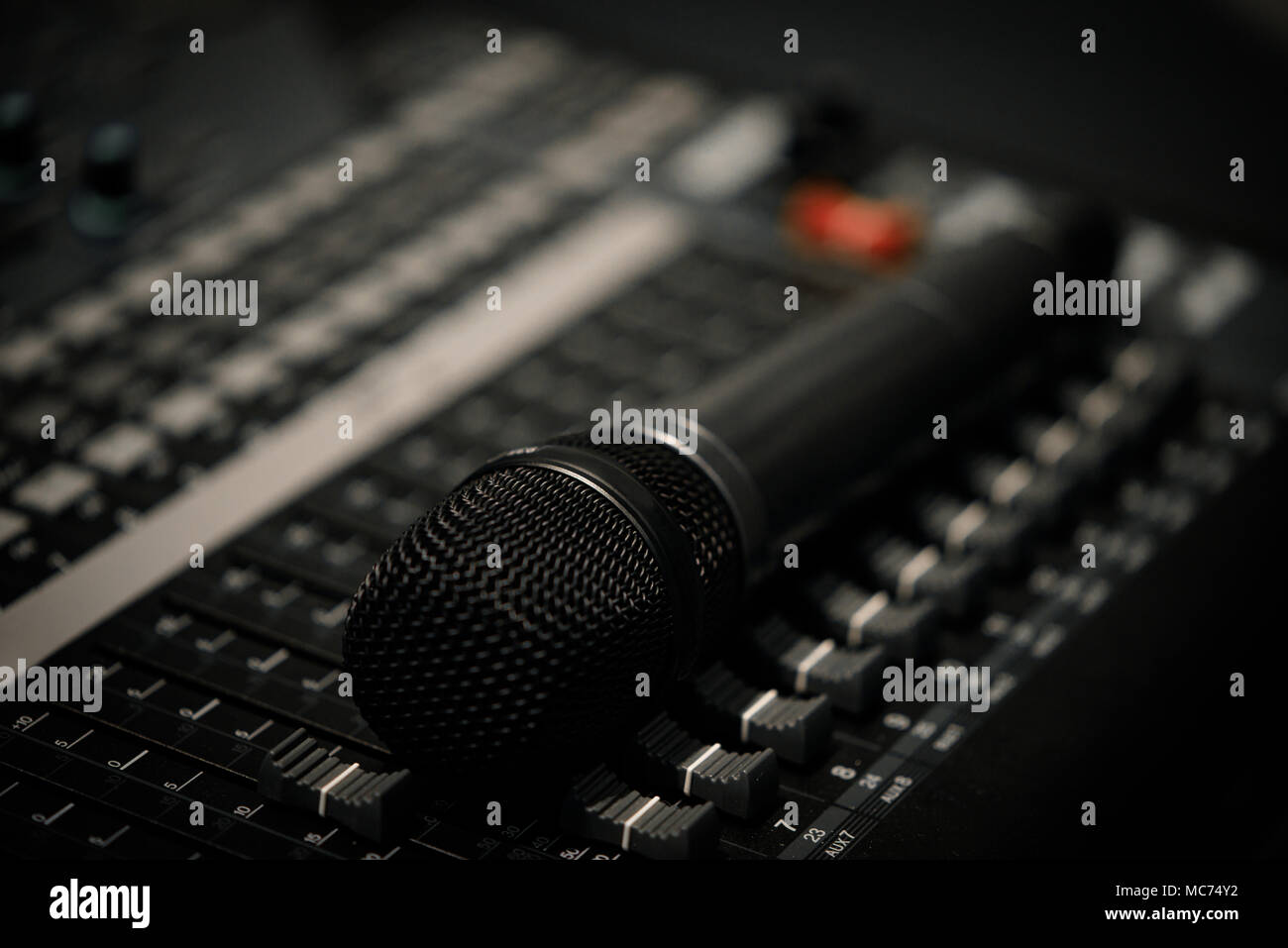 Microphone laying on a mixing desk mixer close Stock Photo - Alamy