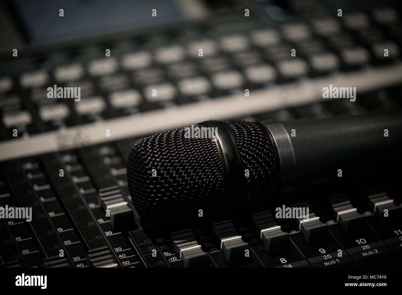 Microphone laying on a mixing desk mixer close Stock Photo - Alamy