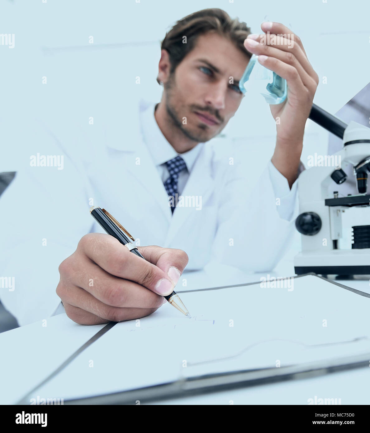 scientist analyzing an experiment in a laboratory Stock Photo - Alamy