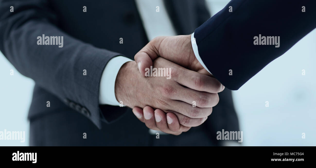 close up of two young male business partner shake hand Stock Photo - Alamy
