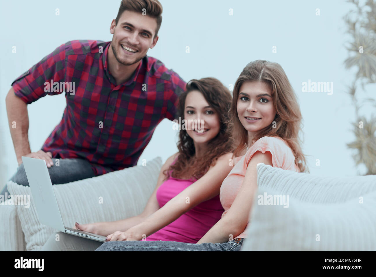 group of young people sitting on the couch in the living room Stock ...