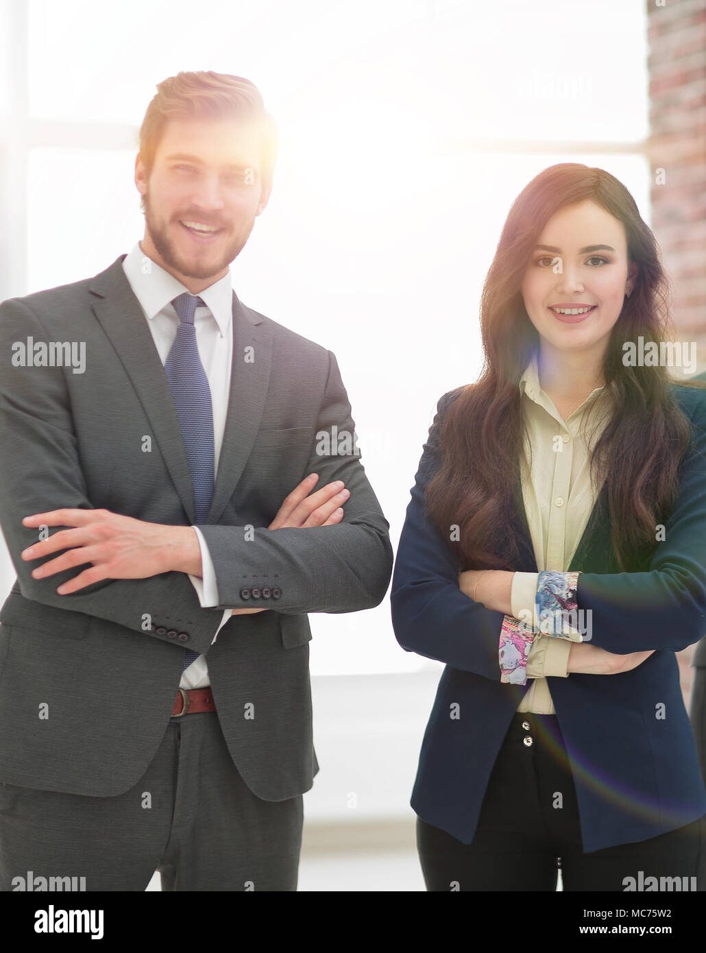Two businesspeople standing together in office Stock Photo - Alamy