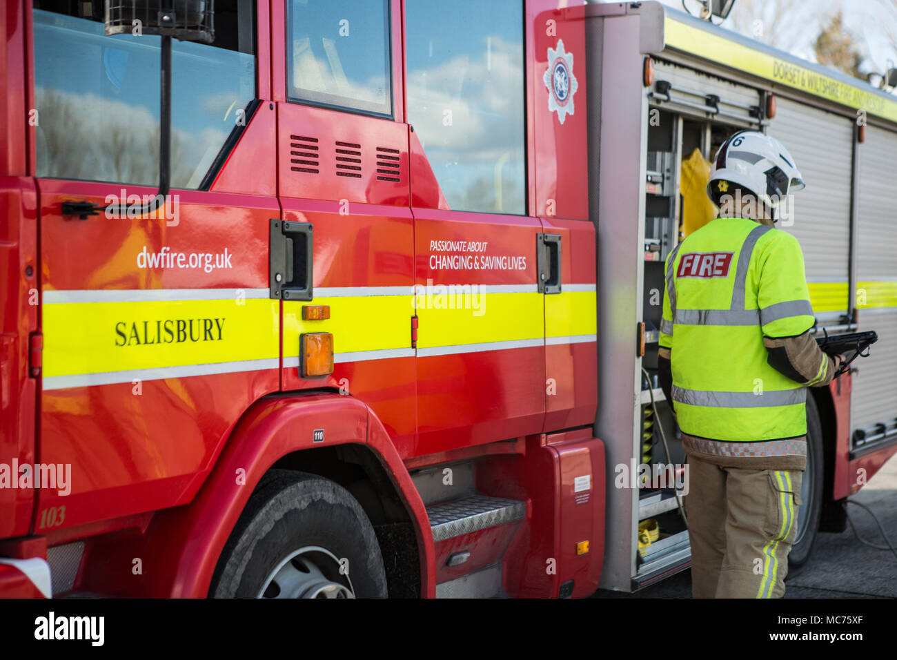 Fireman next to fire engine truck using computer tablet Stock Photo - Alamy